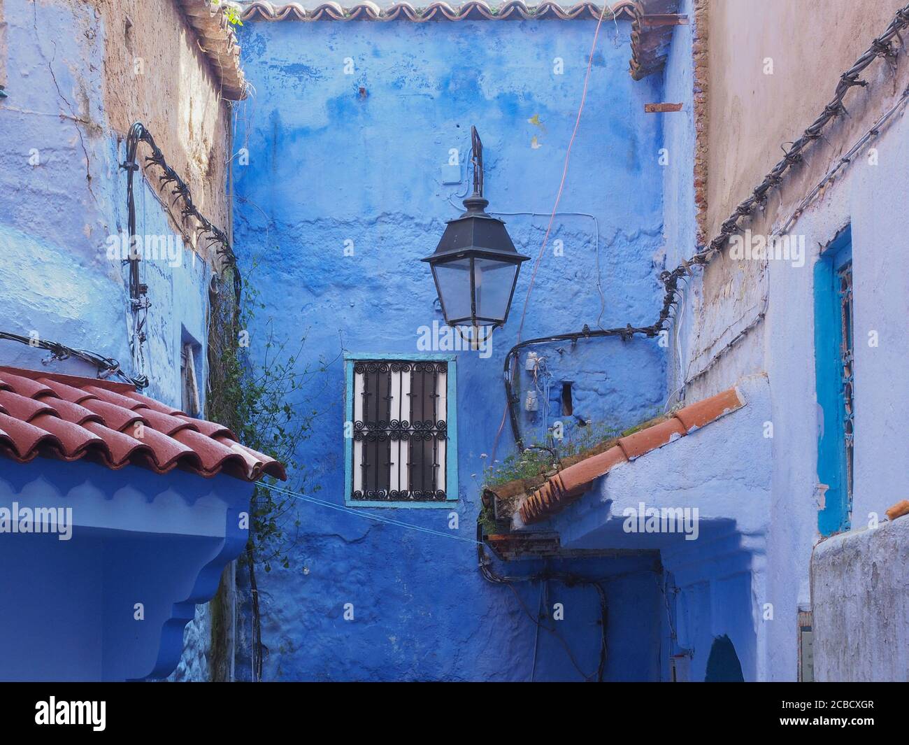 Fragments of walls of an old house blue and red tiles in the medina of ...