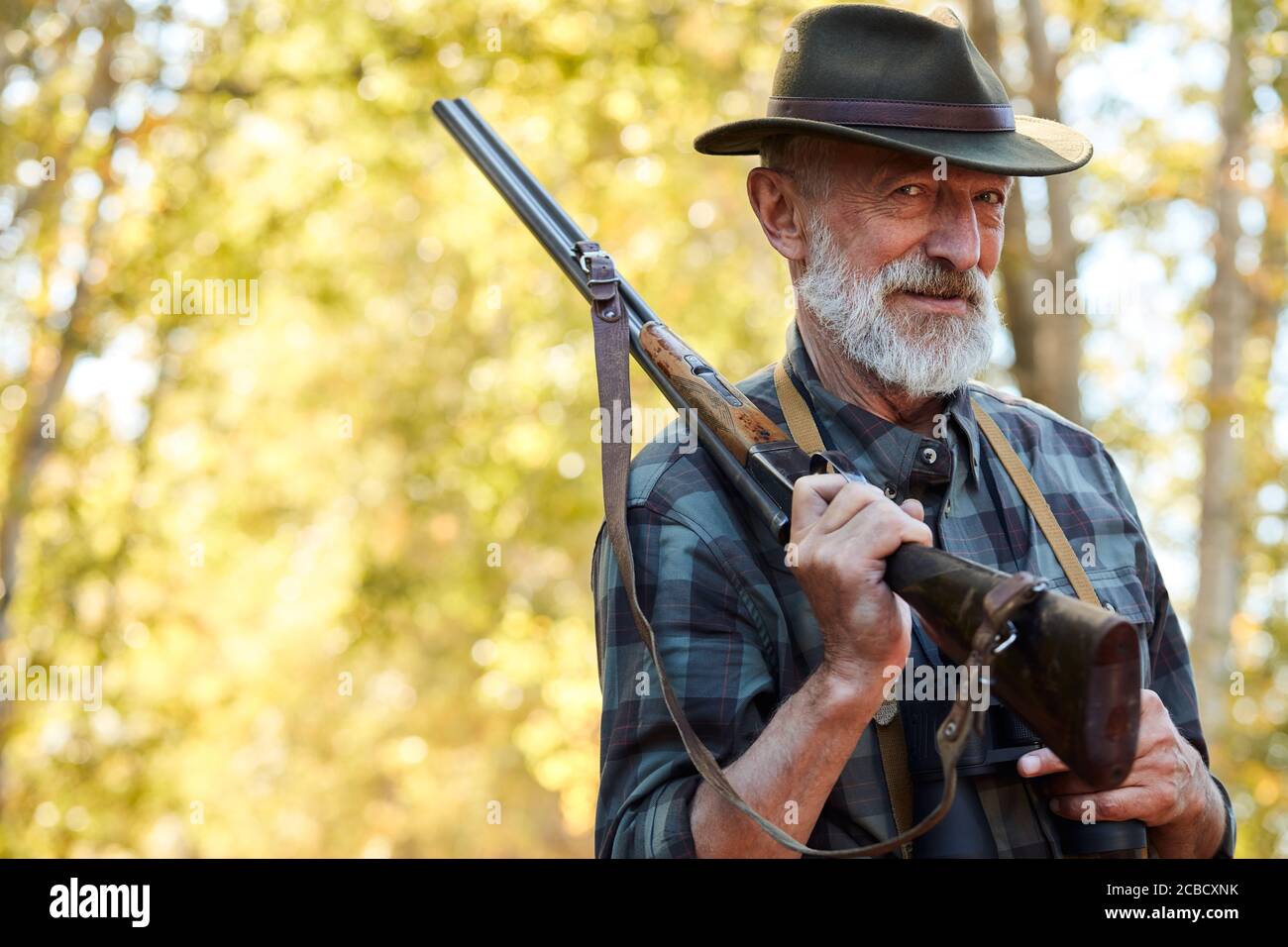 Happy senior hunter smile after getting good, big trophy in forest ...