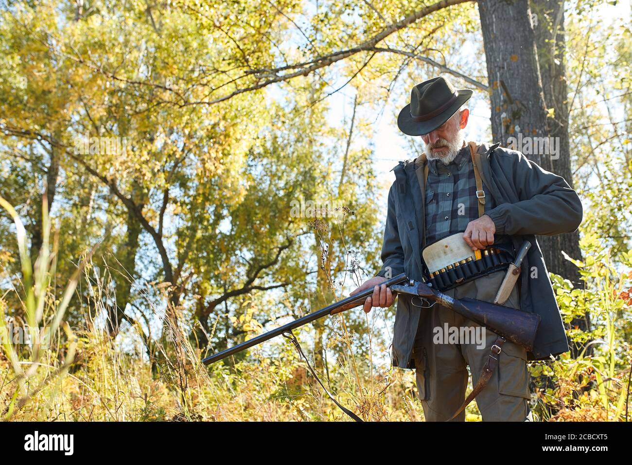 Hunter man load rifle, shotgun going to shoot on wild animals. Hunting ...
