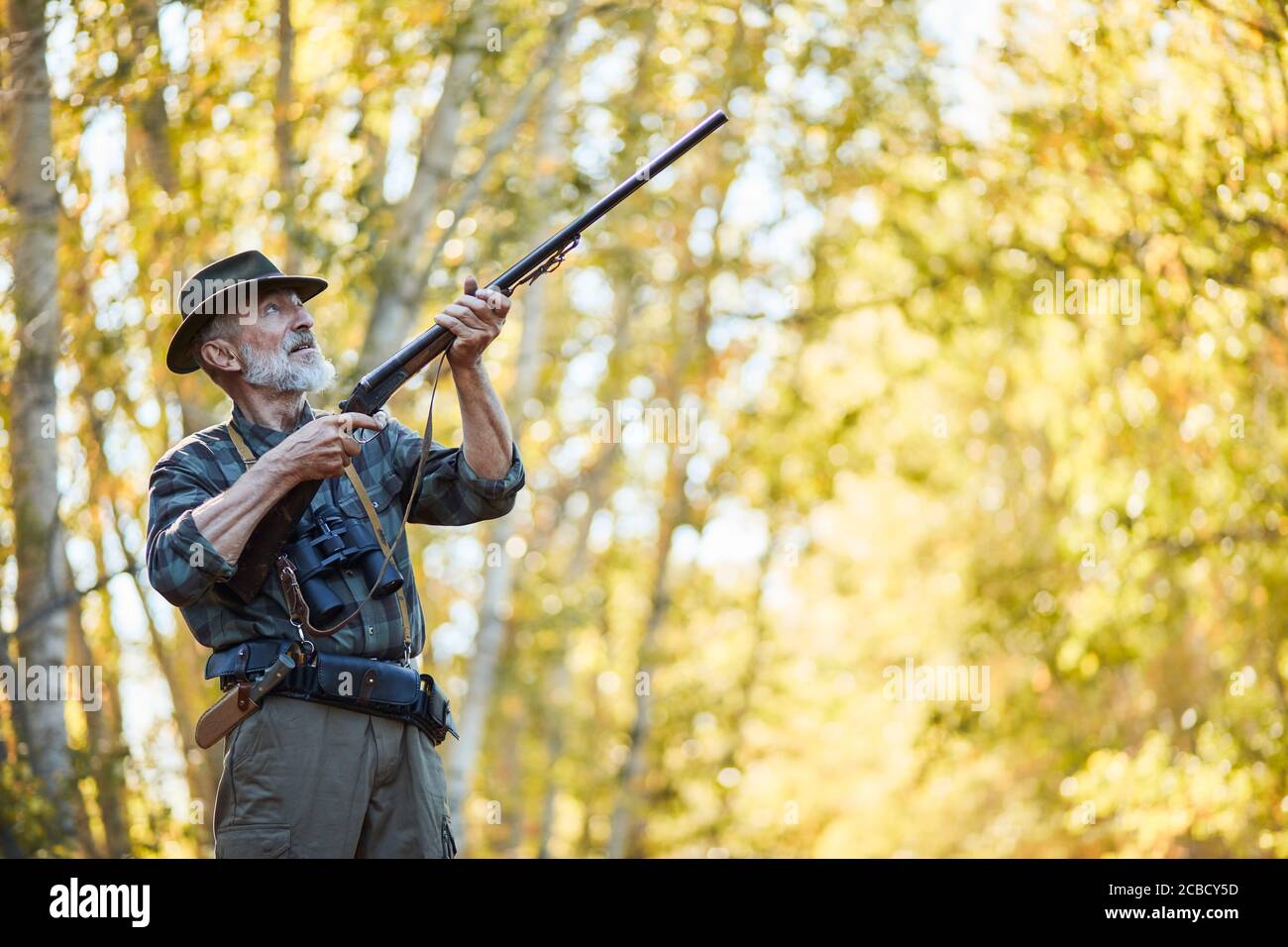 Hunting on wild birds in forest. Caucasian senior man hunt on birds ...