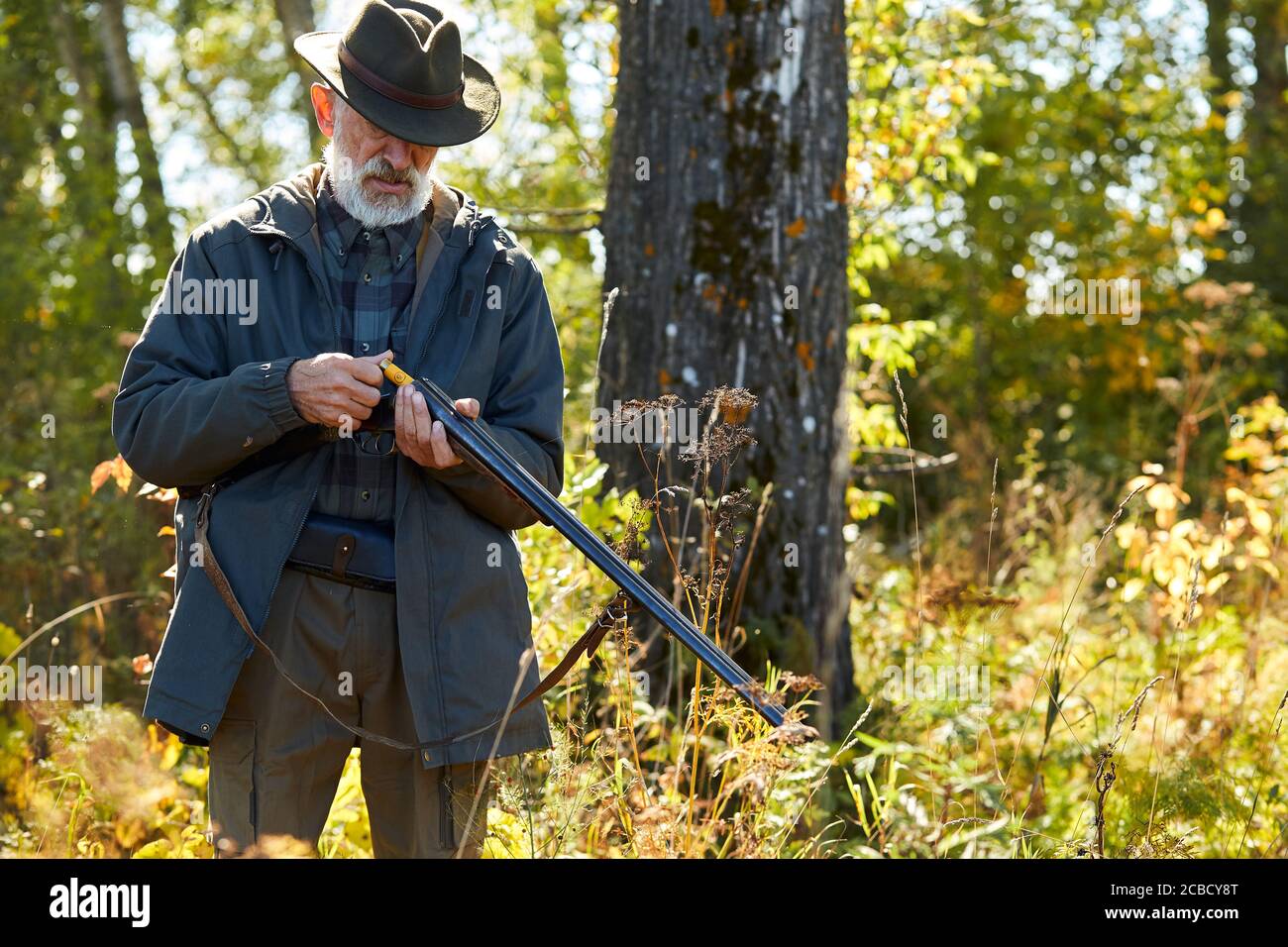 Hunter man load rifle, shotgun going to shoot on wild animals. Hunting ...