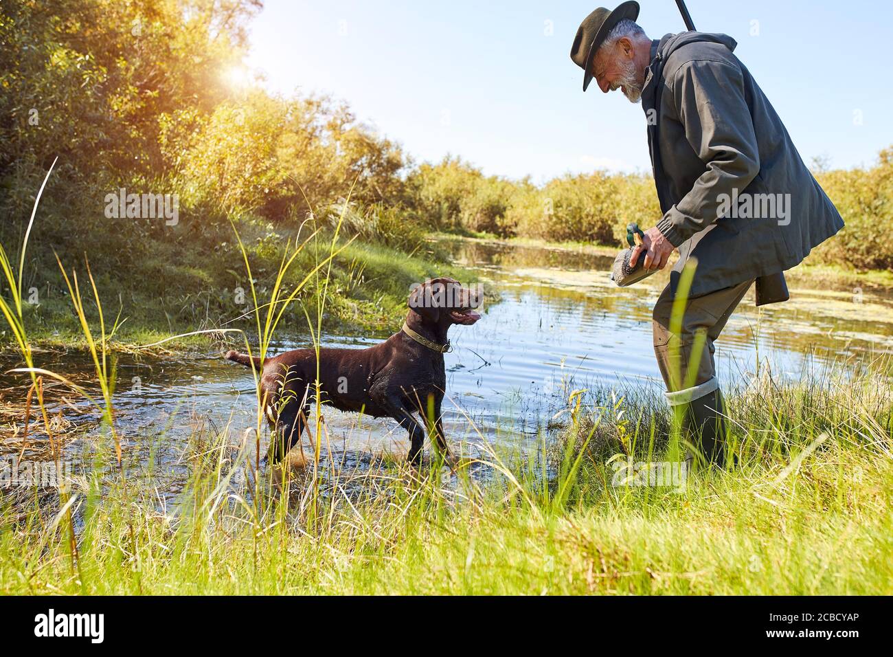 Hunter male came to lake to hunt on duck and caught one duck Stock ...