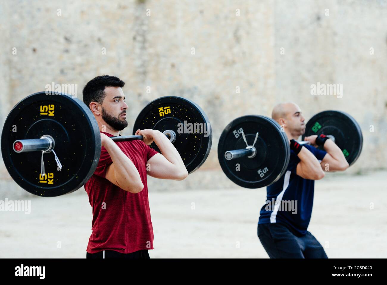 Two weightlifters lifting weights in an urban environment Stock Photo ...