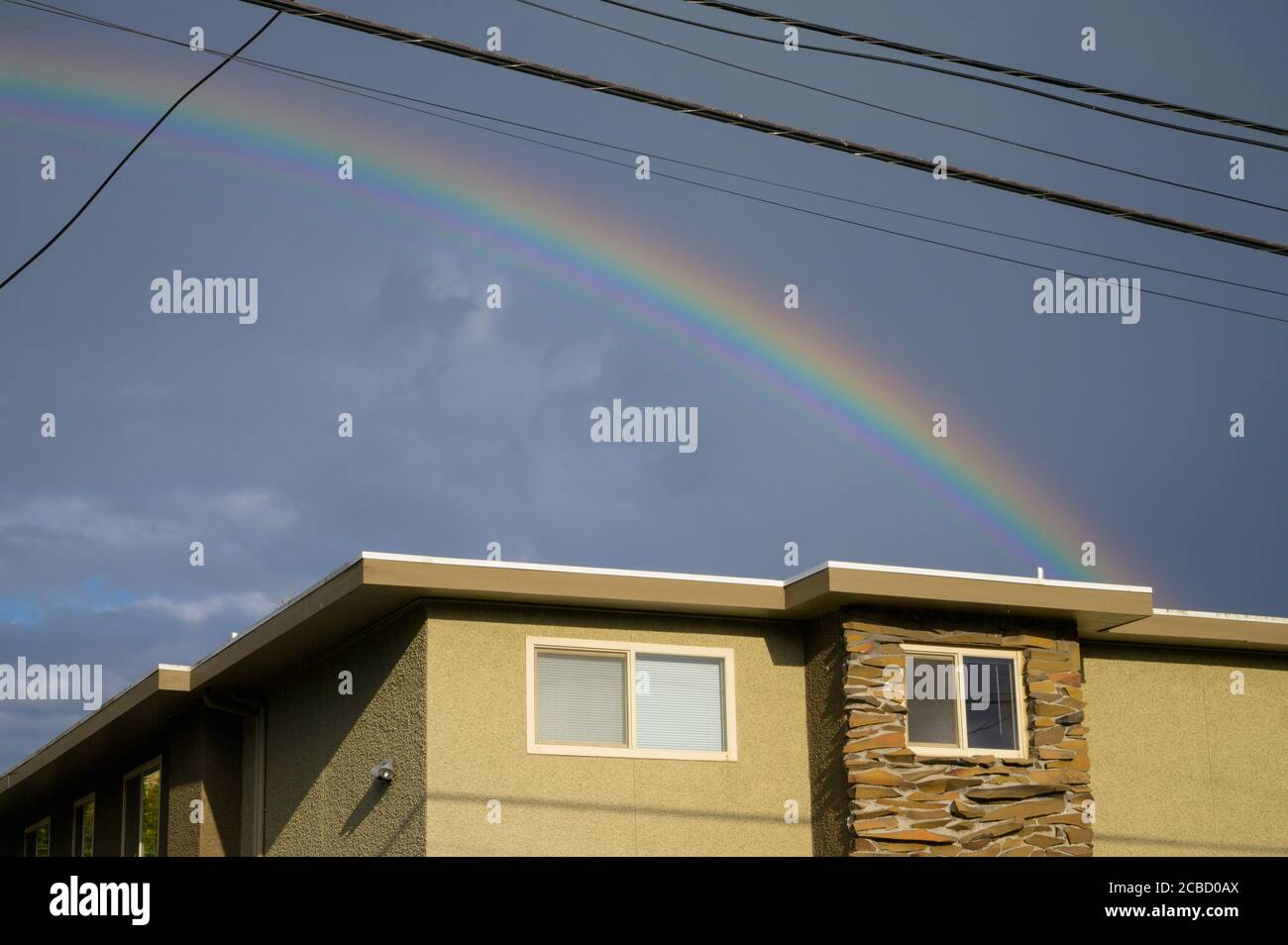Rainbow Over Apartment Building and Blue Sky in The City Stock Photo ...