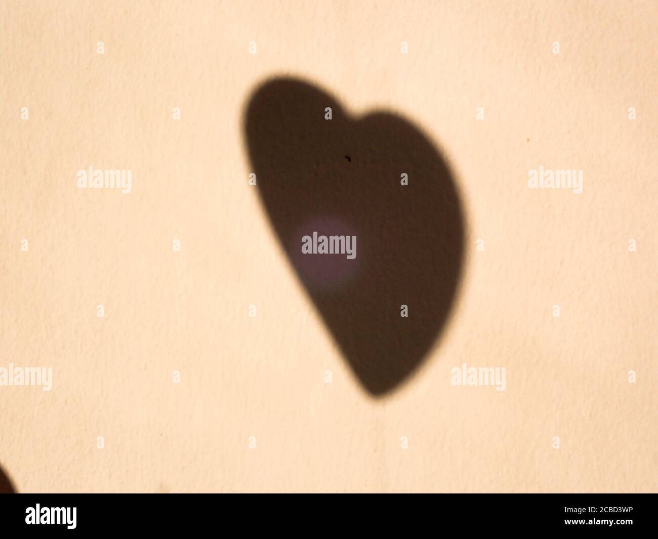 Heart shadows on a wall Stock Photo - Alamy
