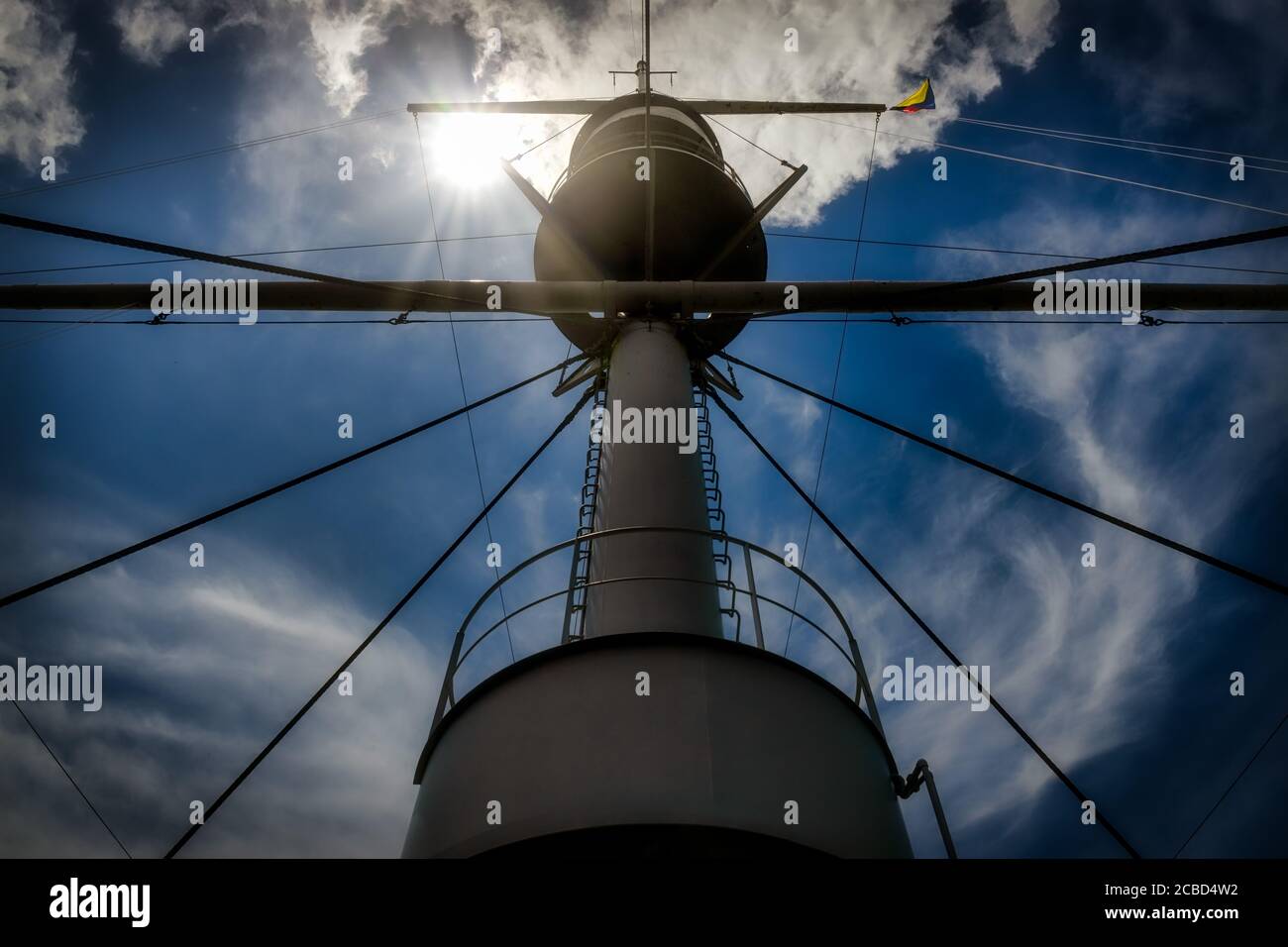 The sun shines on the mast of an old sailing ship on Japan’s east coast ...