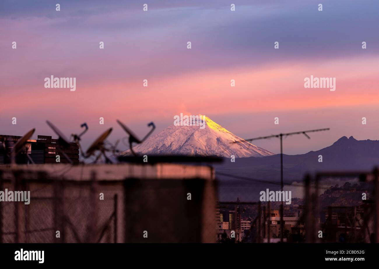 Last sun rays illuminating the active Cotopaxi volcano with small ash ...