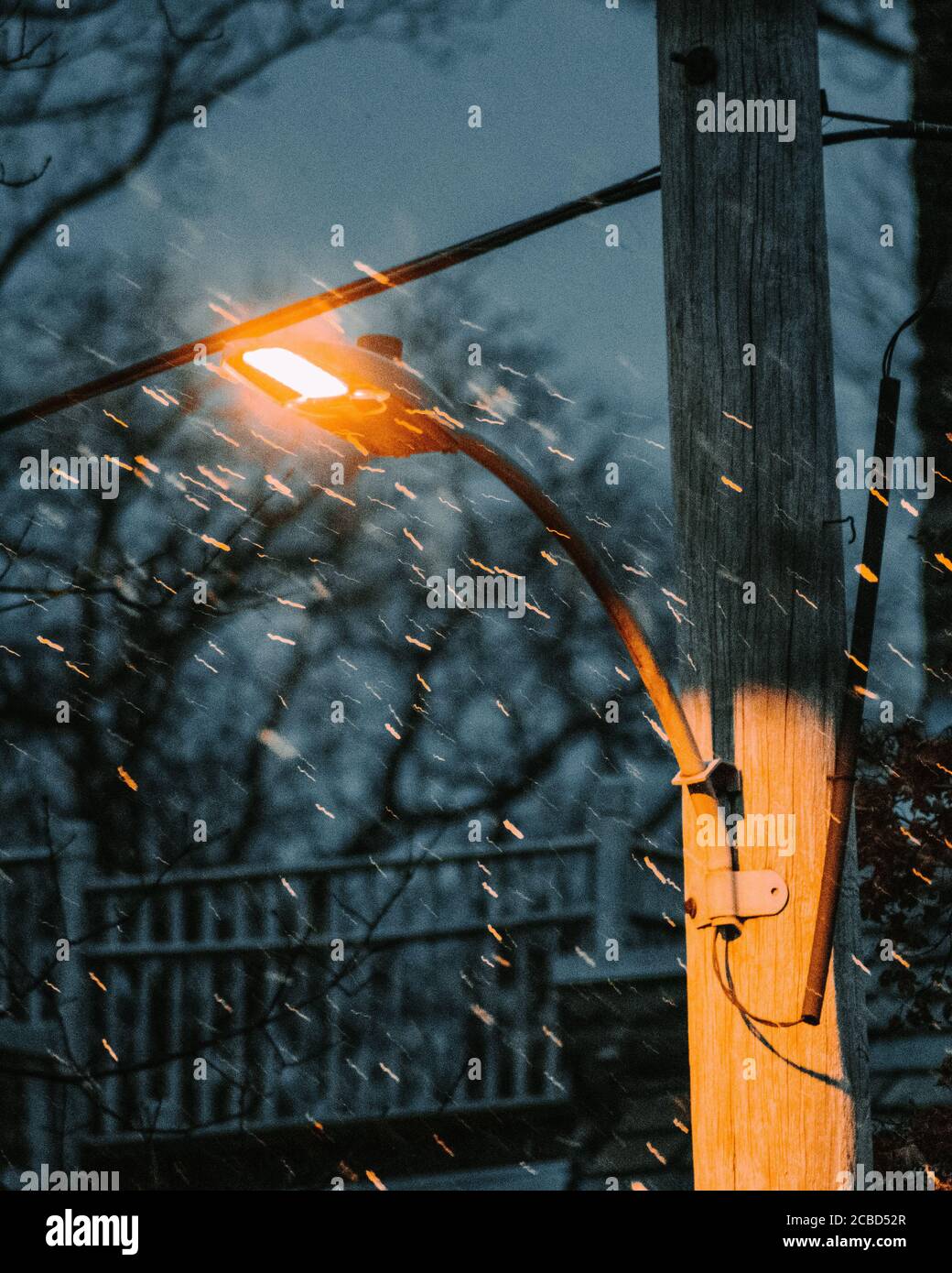 A Light Snow Fall in a Suburban Area Falling in Front of a Street Light ...