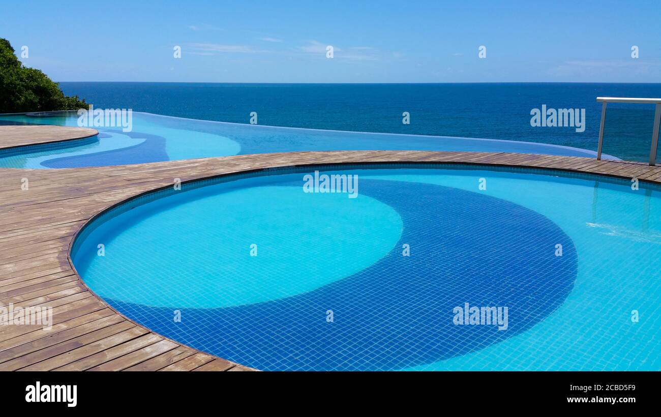 Infinity pool with views of the sea and blue sky Stock Photo - Alamy