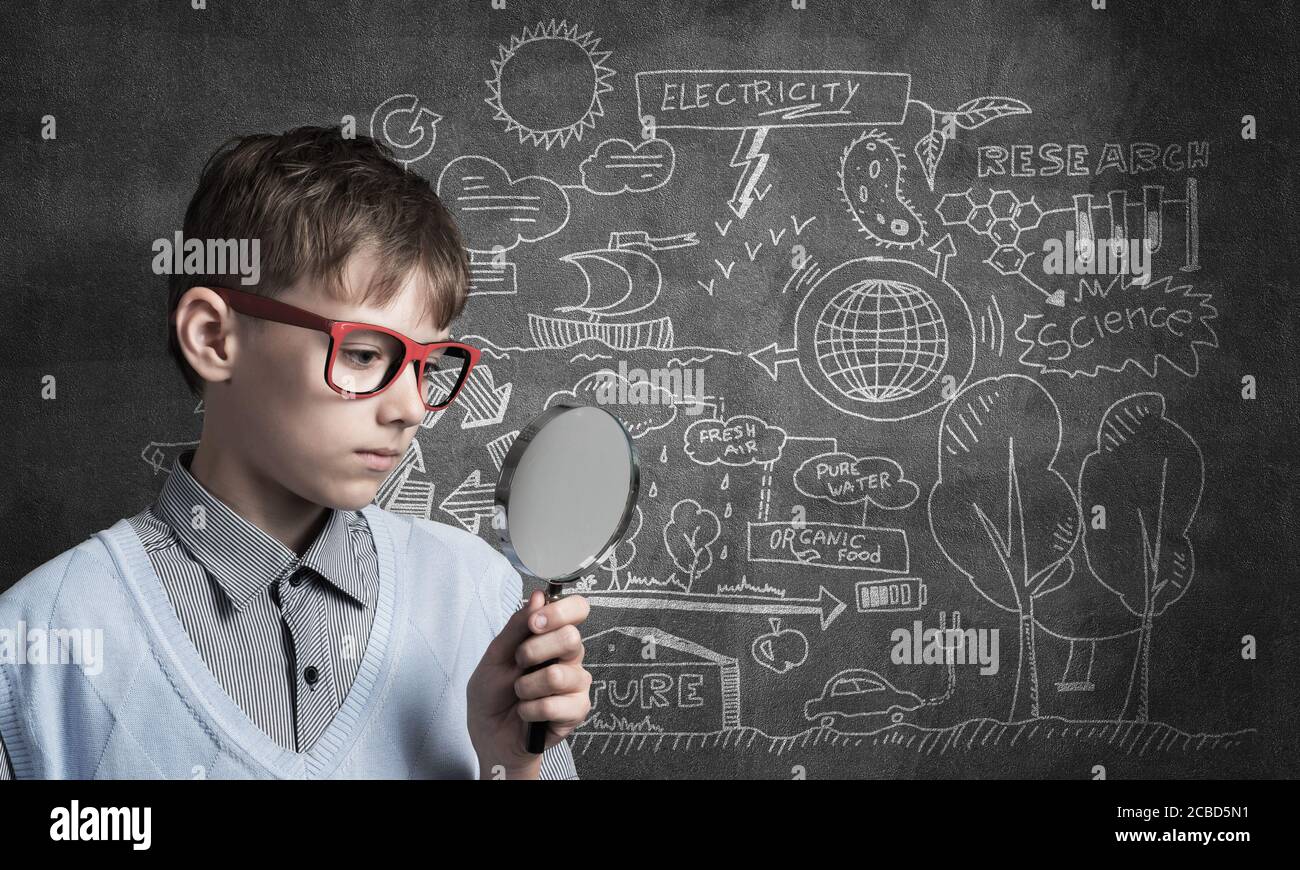 Curious school boy with magnifier Stock Photo - Alamy