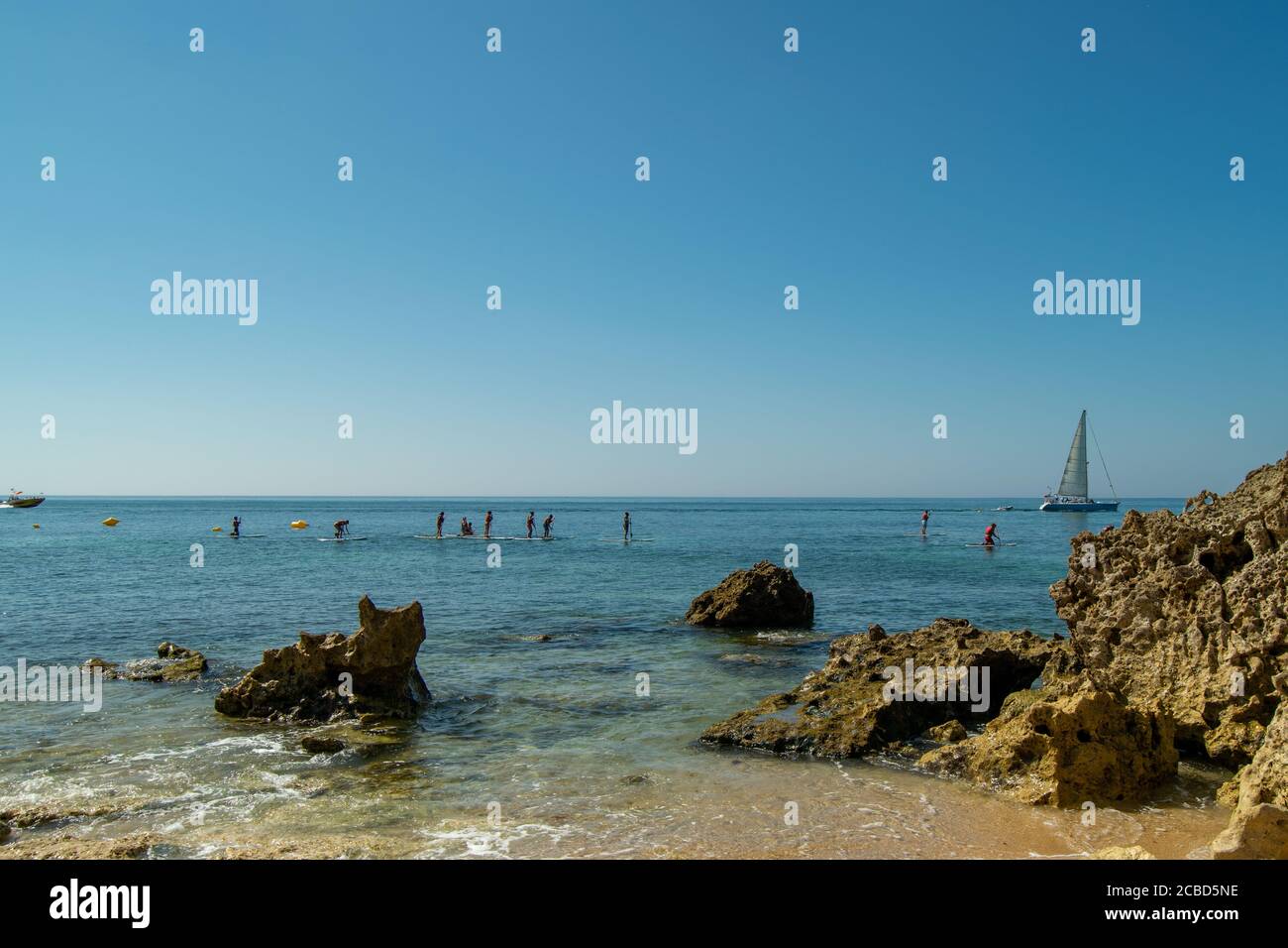 Praia da Oura, group of people practicing paddling in Algarve Portugal ...