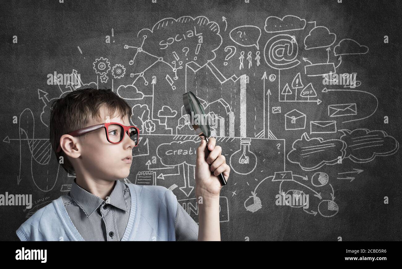 Curious school boy with magnifier Stock Photo - Alamy