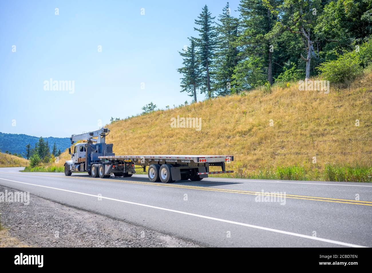 White big rig semi truck with crane application on the frame ...