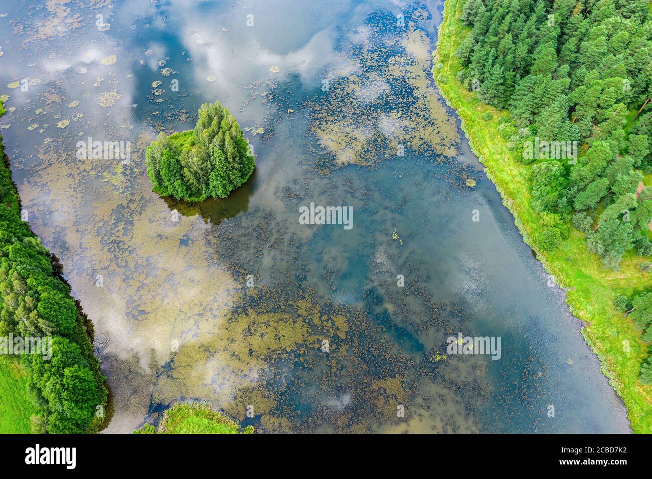 summer rural area landscape. water pond with small island and cloudy ...