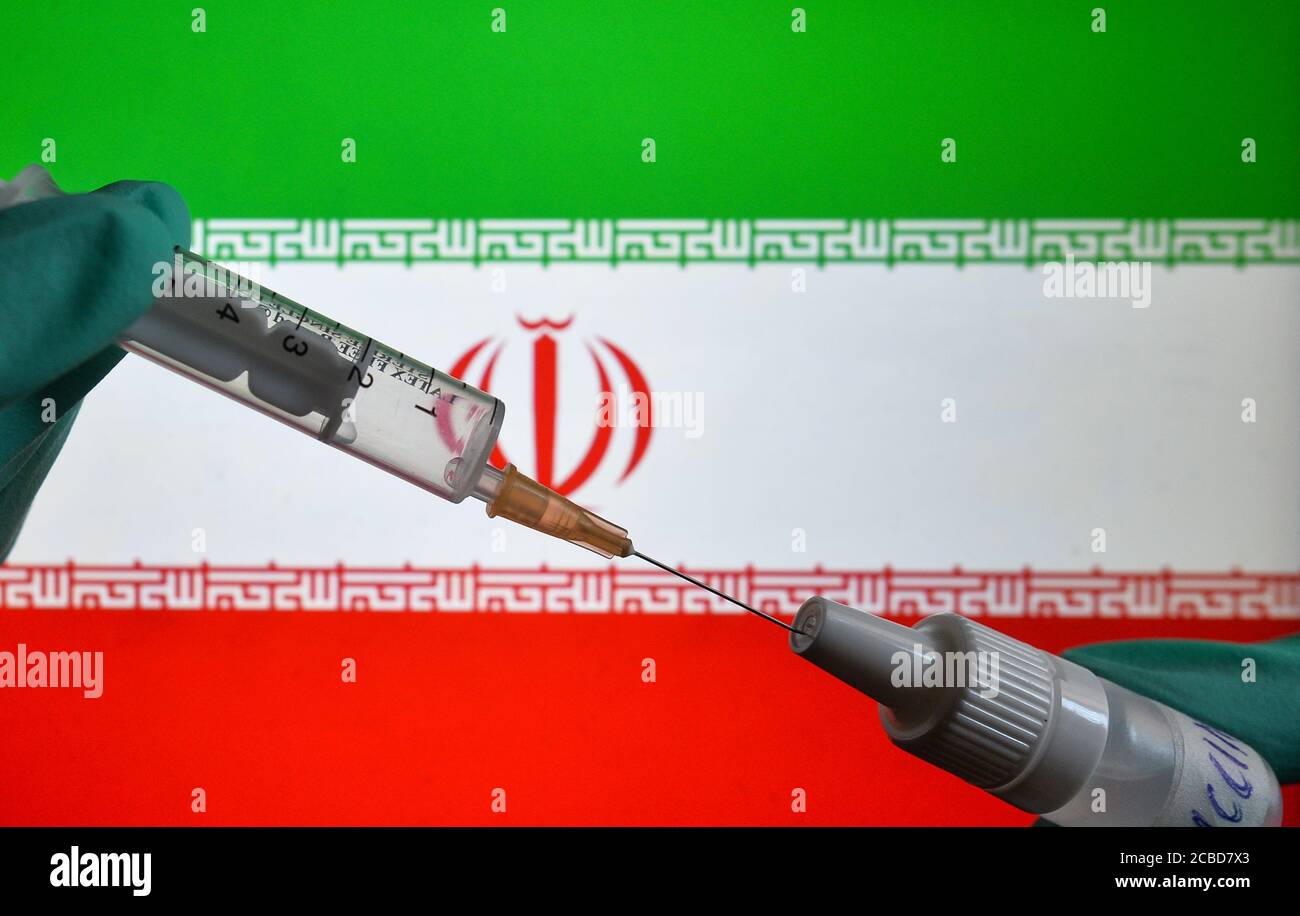 In this photo illustration a medical syringe and the flag of Iran in ...