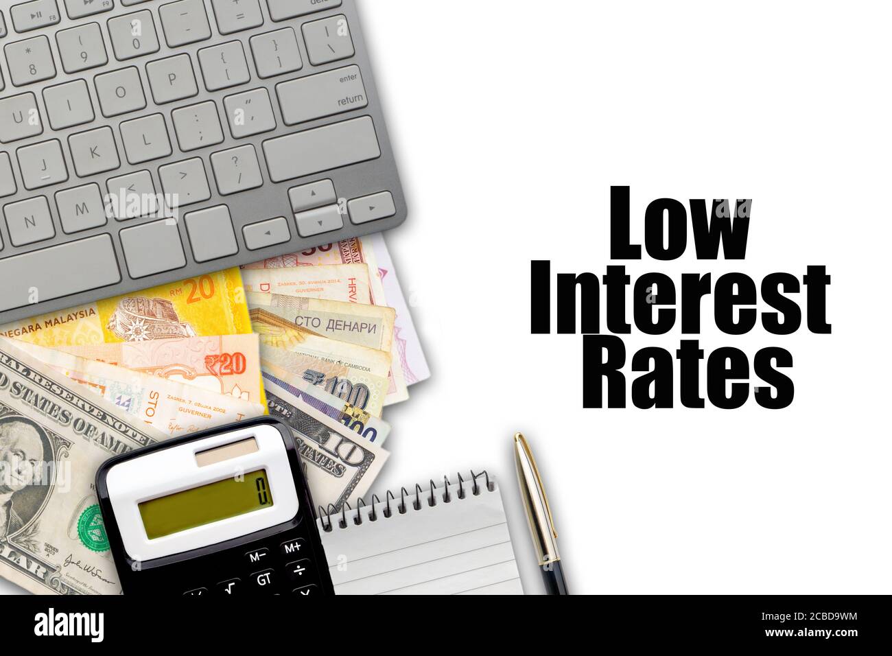 LOW INTEREST RATES text with fountain pen, keyboard, calculator ...