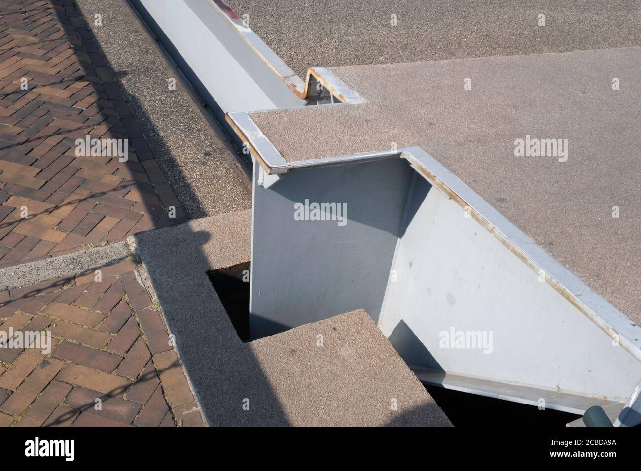 Close up of a descending drawbridge that will be locked in the road ...