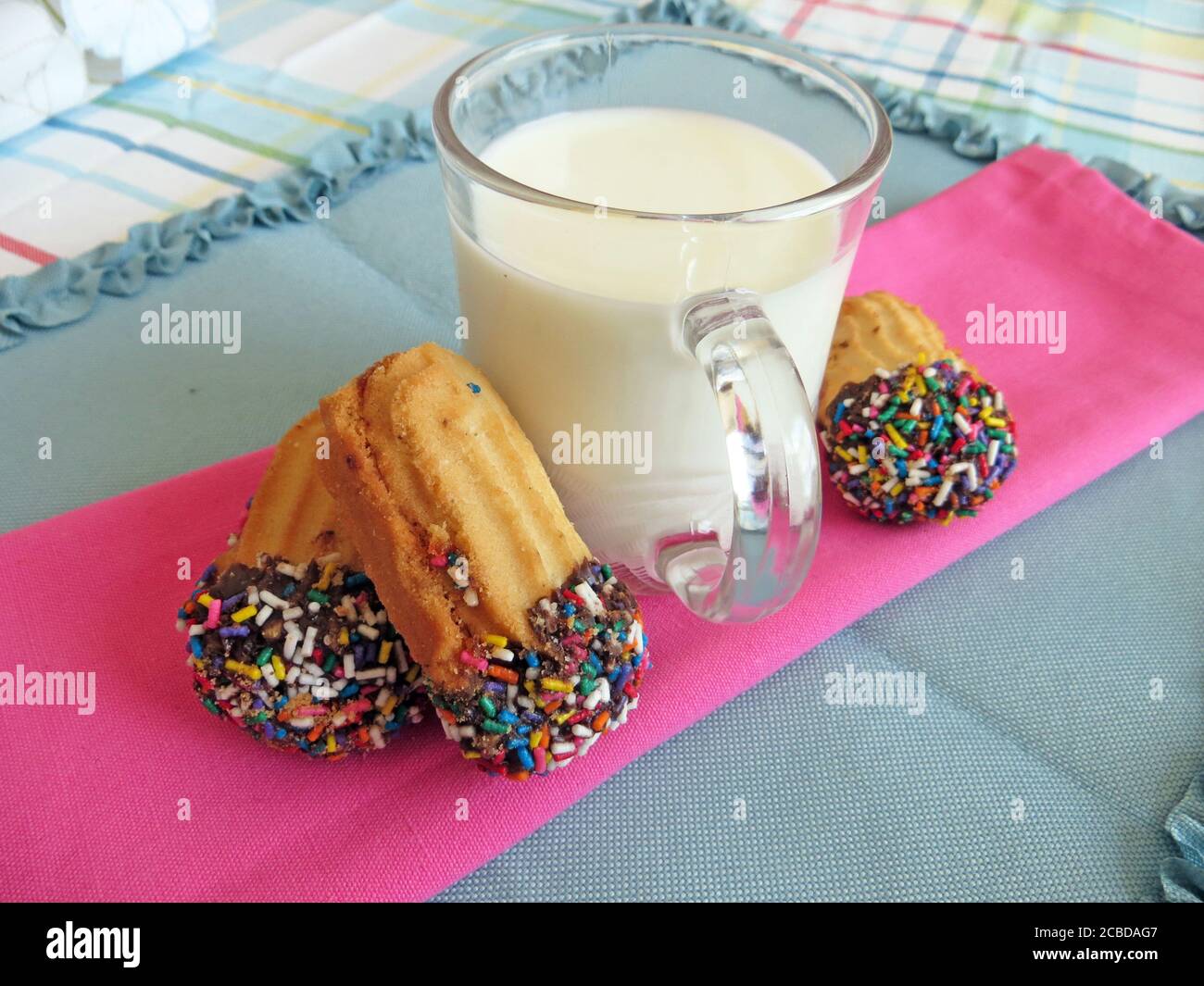 Cookies with sprinkles and a glass of milk Stock Photo - Alamy