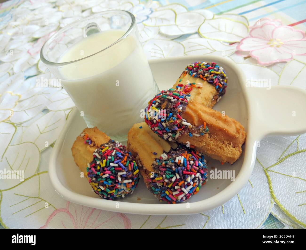 Cookies with sprinkles and a glass of milk Stock Photo - Alamy
