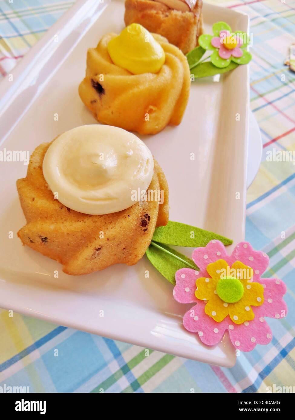 Three little cakes with a variety of frostings Stock Photo - Alamy