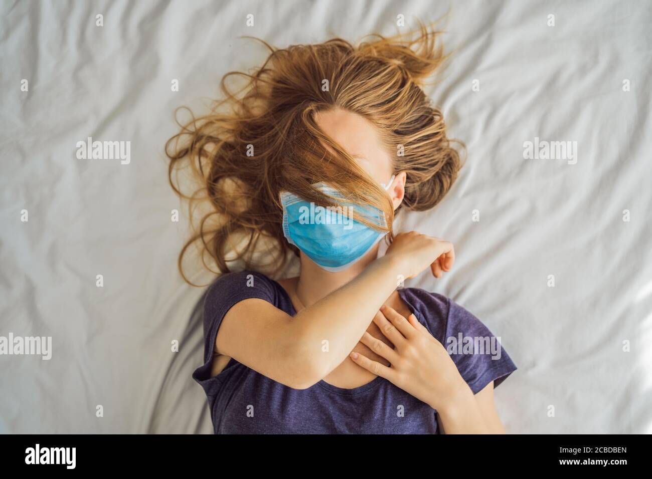 Extremly tired young woman lying on the bed, home alone. self-isolation ...