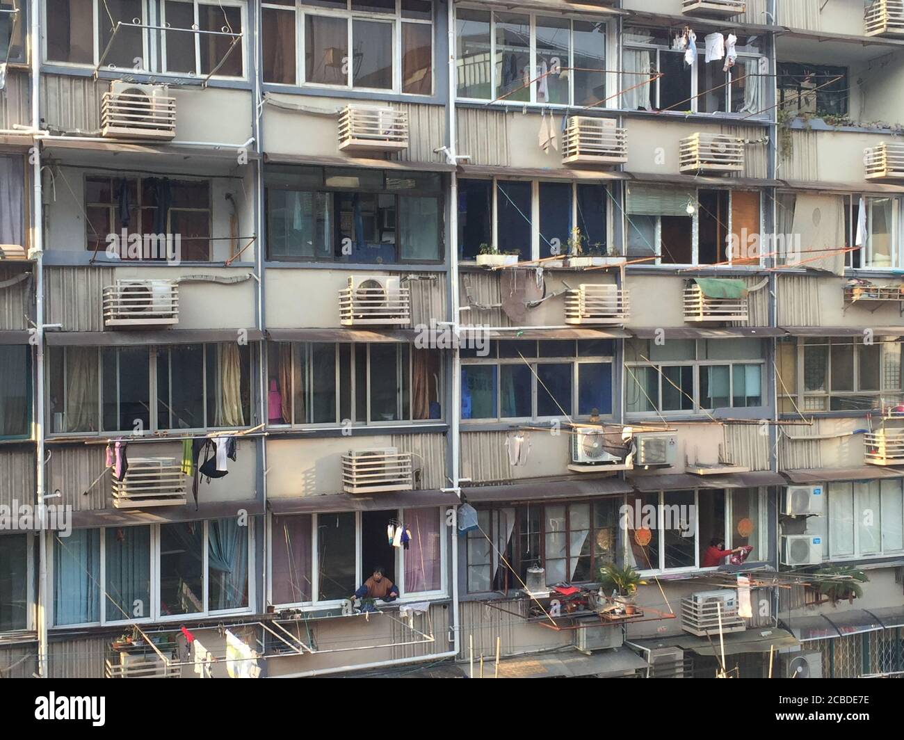 Facade of an old apartment apartment building with windows and air ...