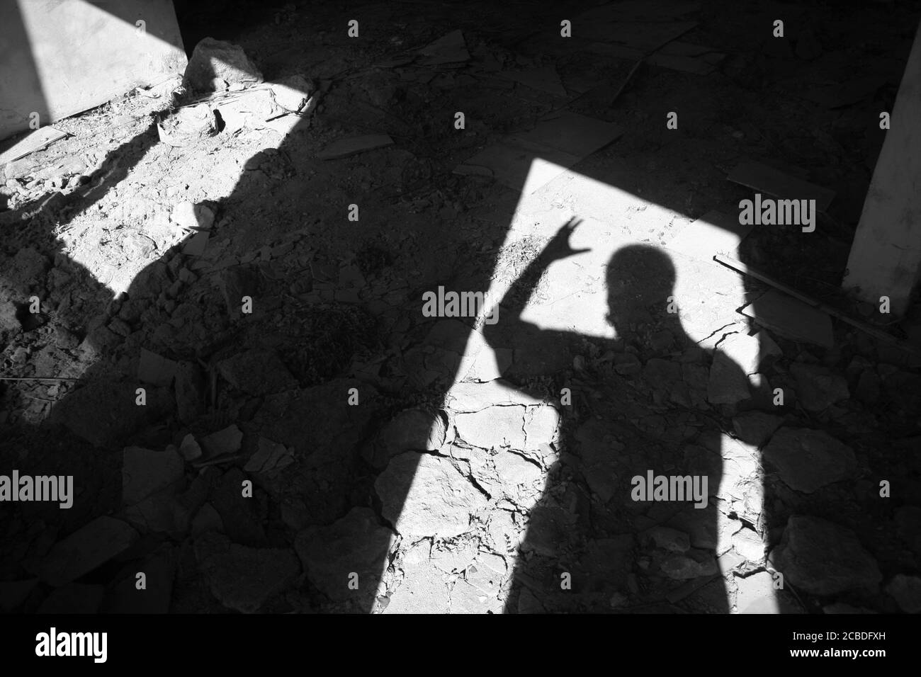 High angle grayscale shot of the photographer's shadow inside of an ...
