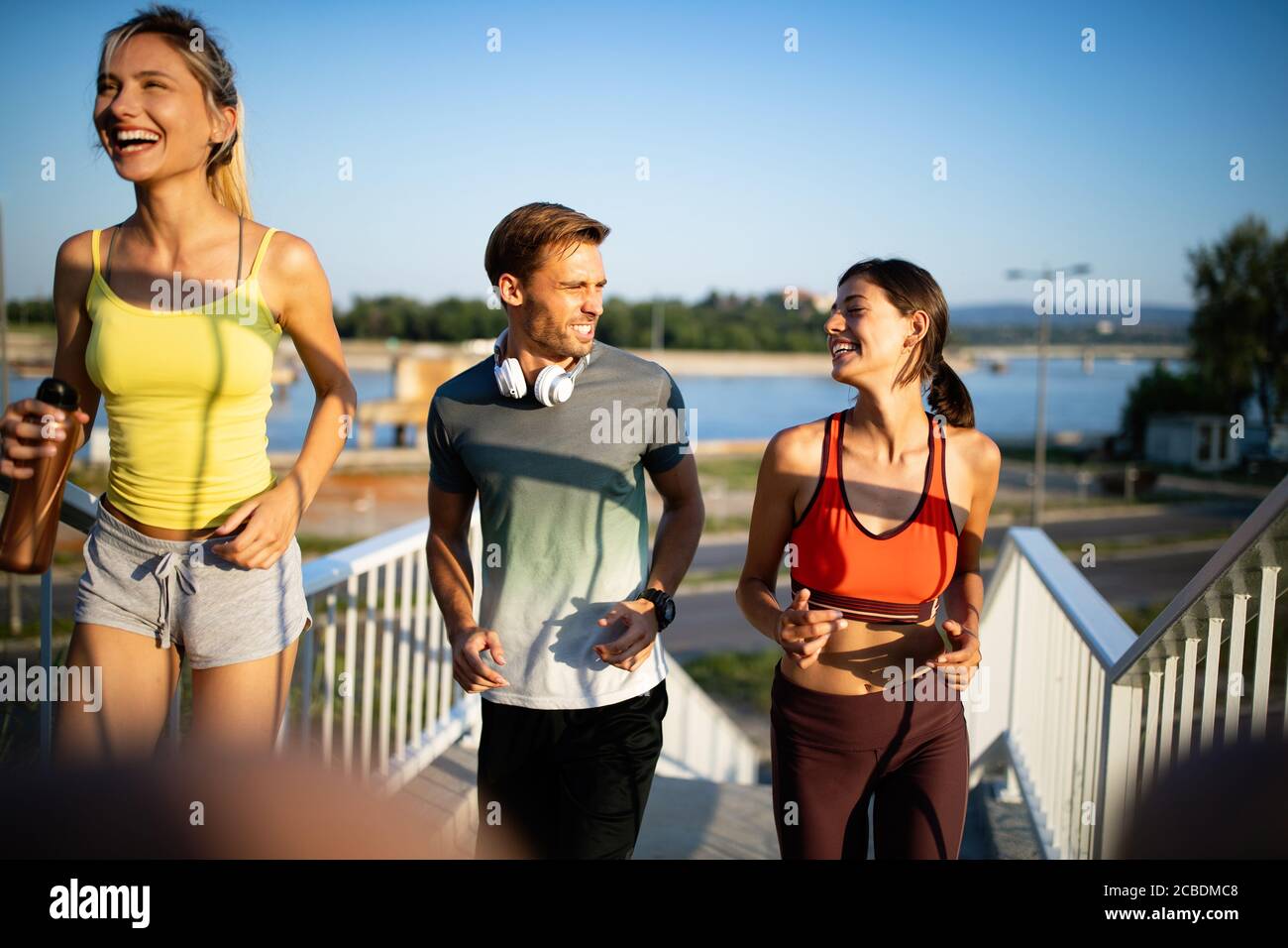 Fitness, sport, people and running concept. Happy fit friends running ...