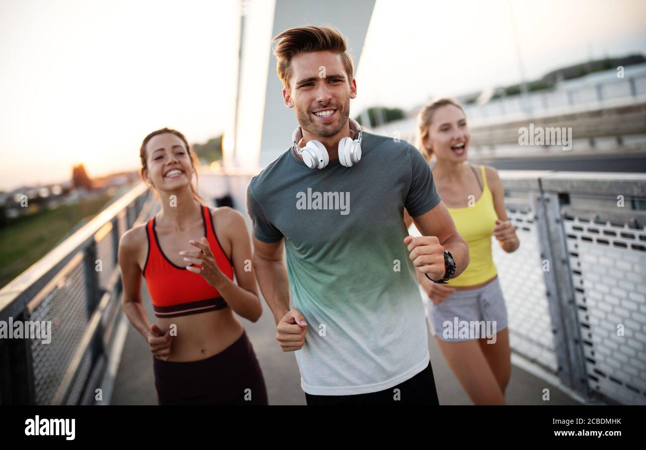Fitness, sport, people and running concept. Happy fit friends running ...