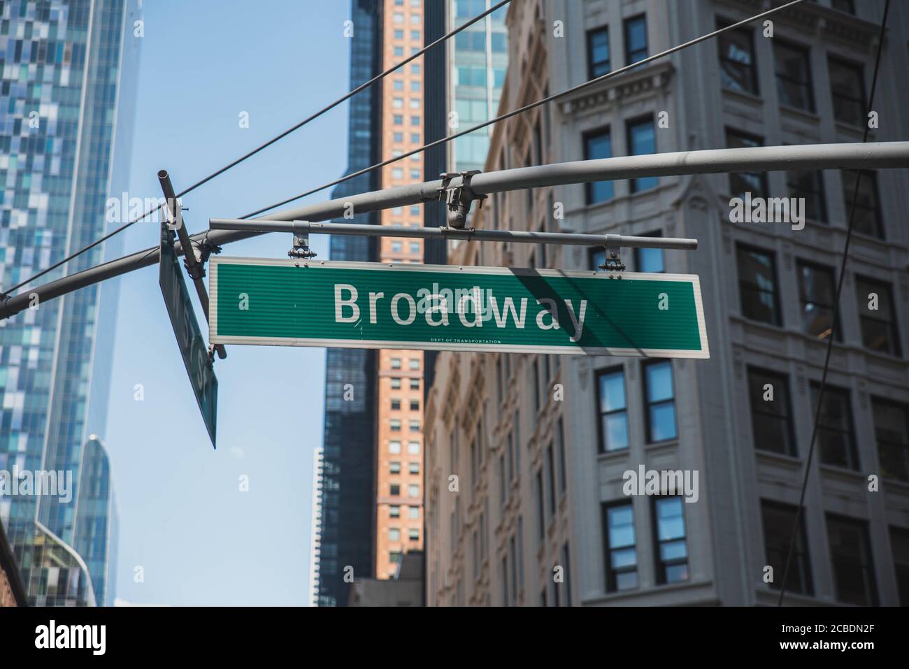 Green street sign with text "Broadway" hanging on a street pole Stock ...