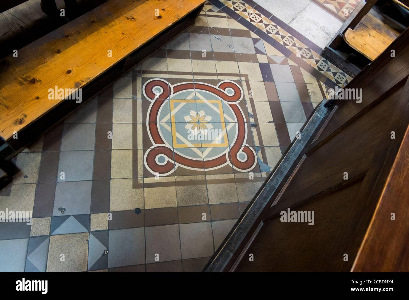 Floor tile pattern detail, design inbetween wooden pews, rows at the ...
