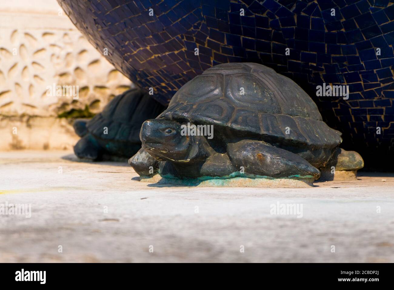 A close up, detail view of the support bronze turtles under the planter ...
