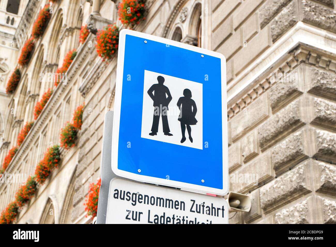 A typical metal, blue mounted street sign for a man and woman standing ...