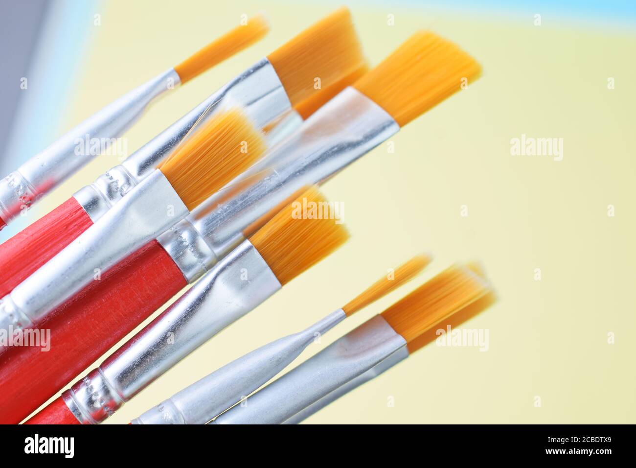 Set of paint brushes on yellow background Stock Photo - Alamy