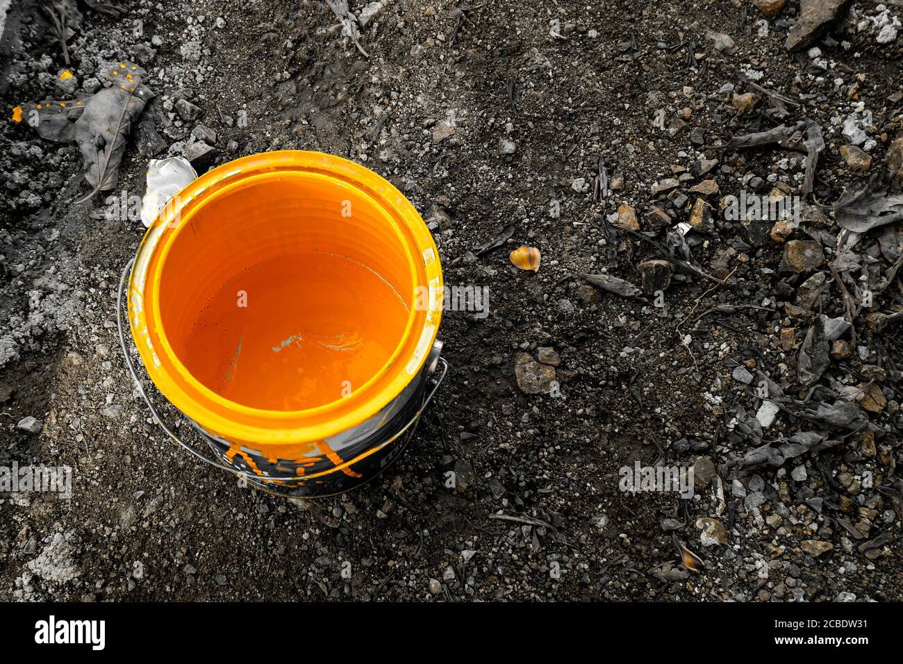 a close view of yellow color bucket on ground Stock Photo - Alamy