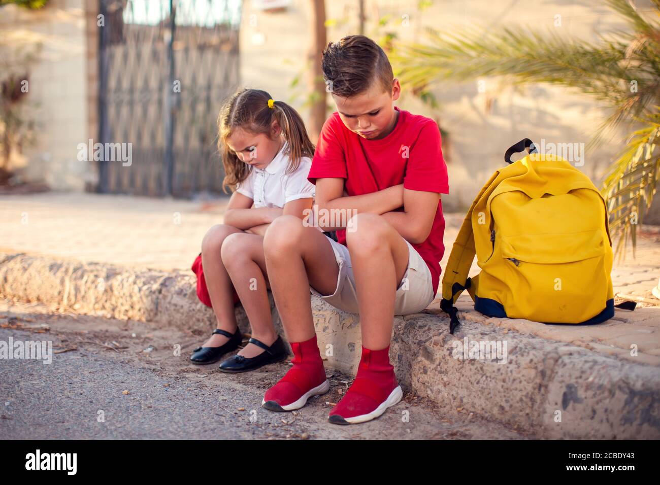 Upset pupils taking offense to each other outdoor. Children and ...