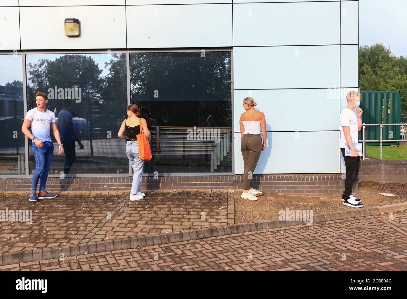 Sixth form students waiting in line, social distancing, for A Level ...
