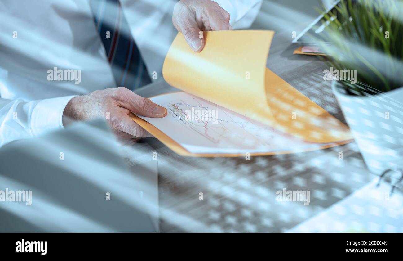 Businessman opening folder with paper documents; light effect Stock ...
