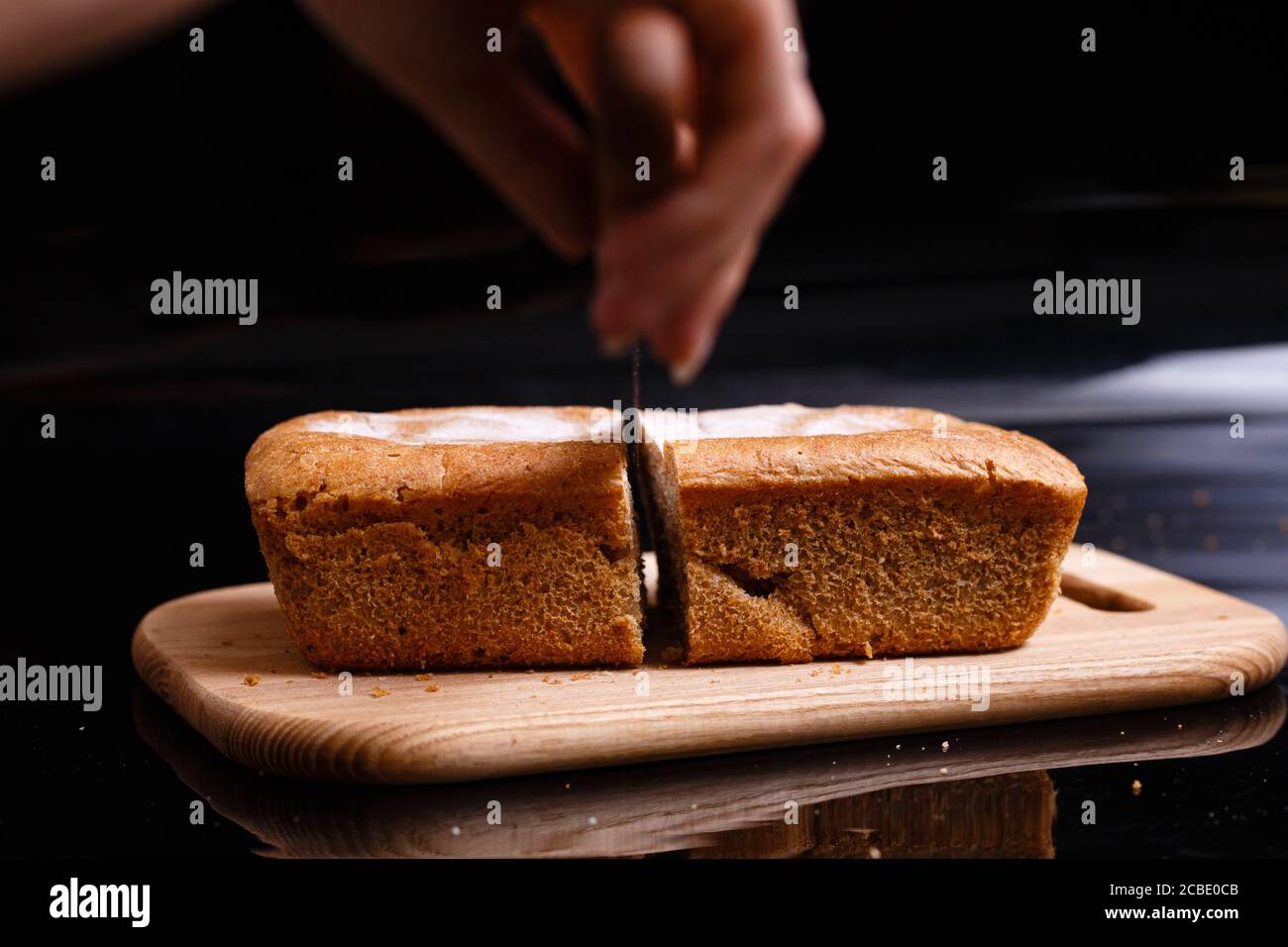 Homemade gray bread on a black background. Photo in section Stock Photo ...