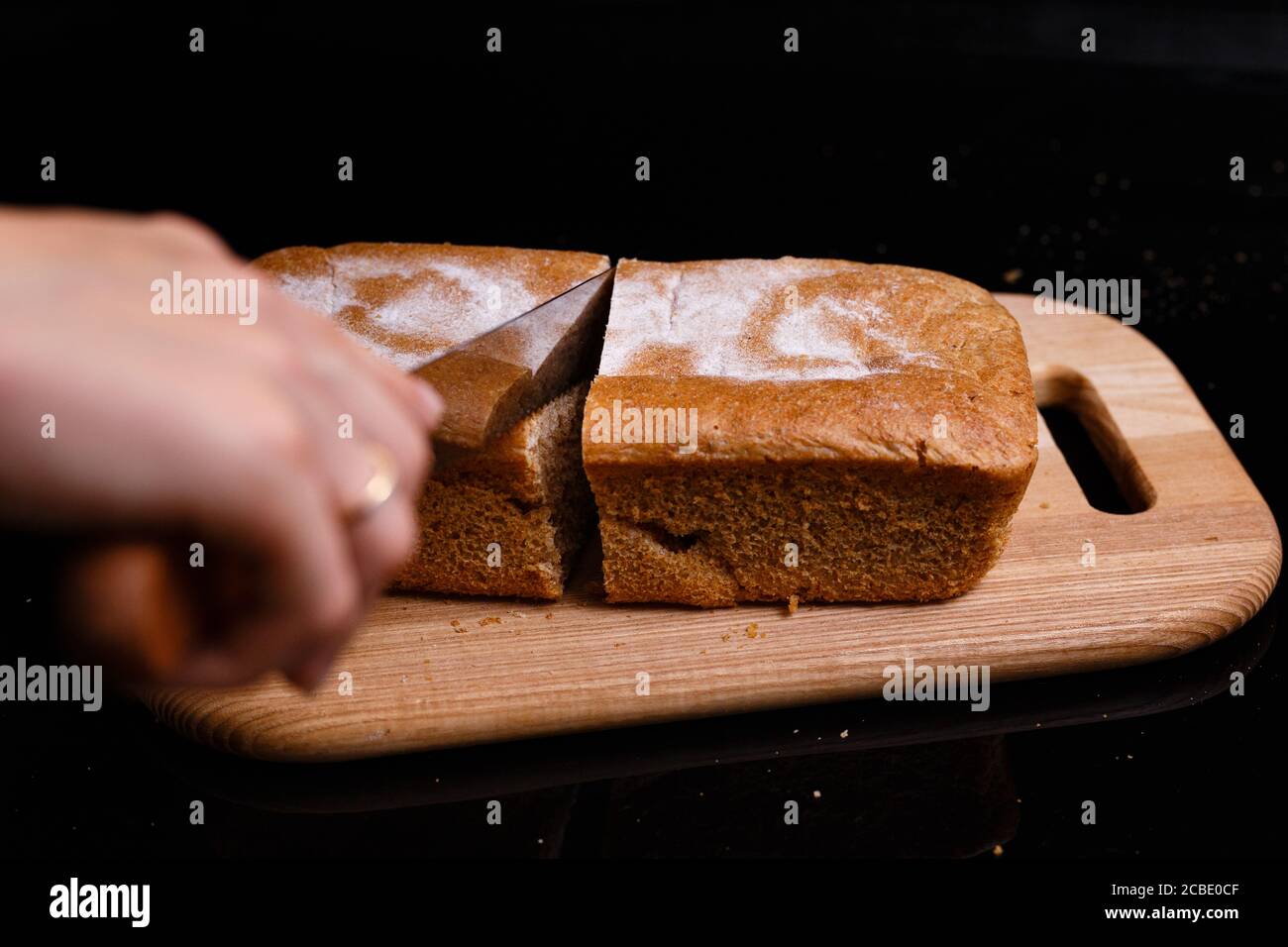 Homemade gray bread on a black background. Photo in section Stock Photo ...