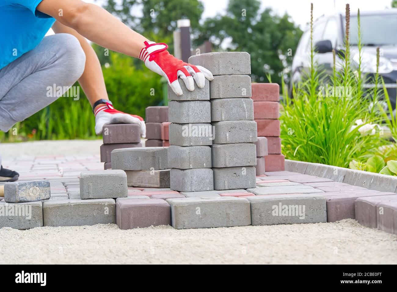 worker laying paving stones. stone pavement, construction worker laying ...