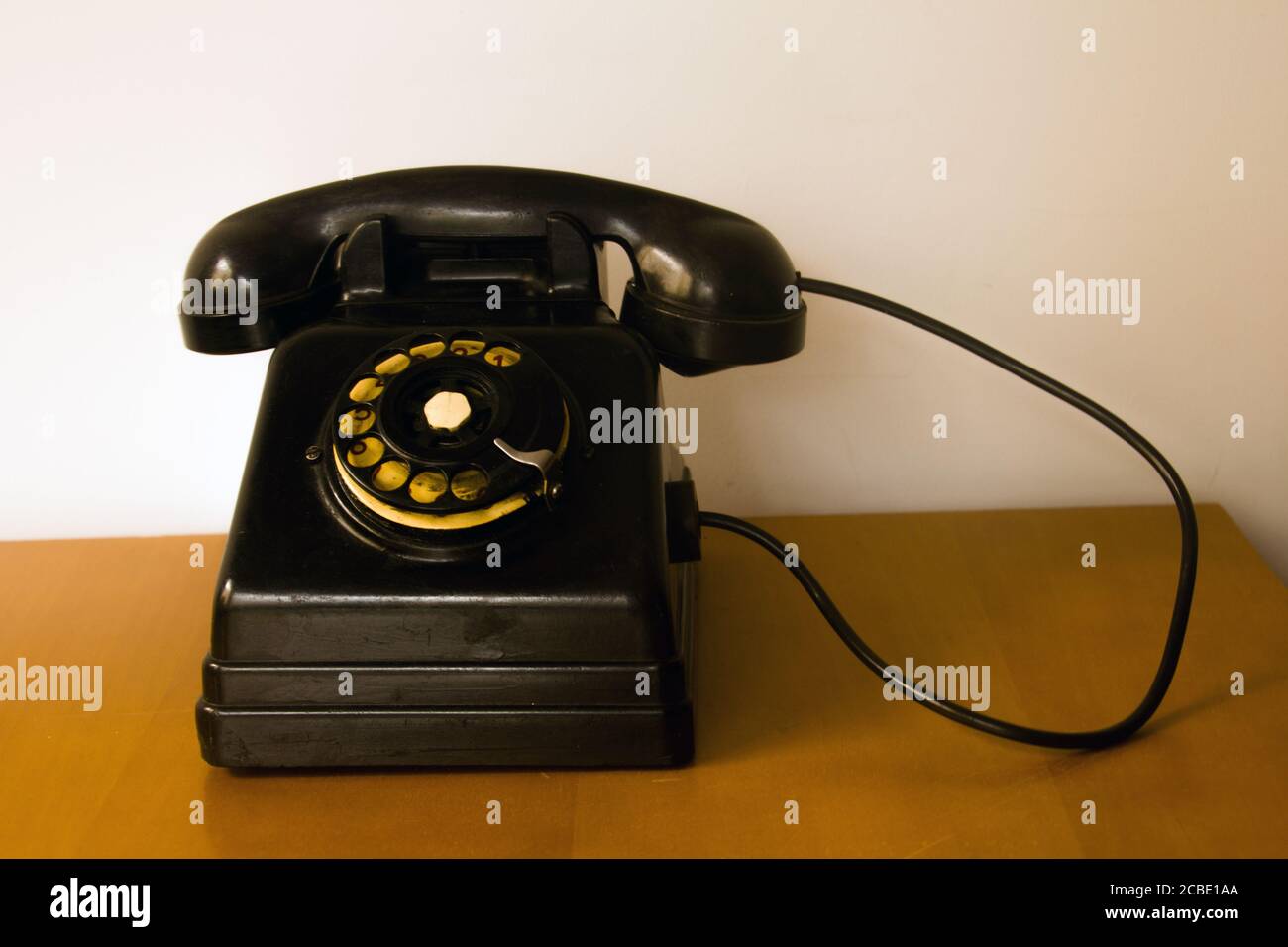 old telephone with rotating disc placed on a furniture Stock Photo - Alamy