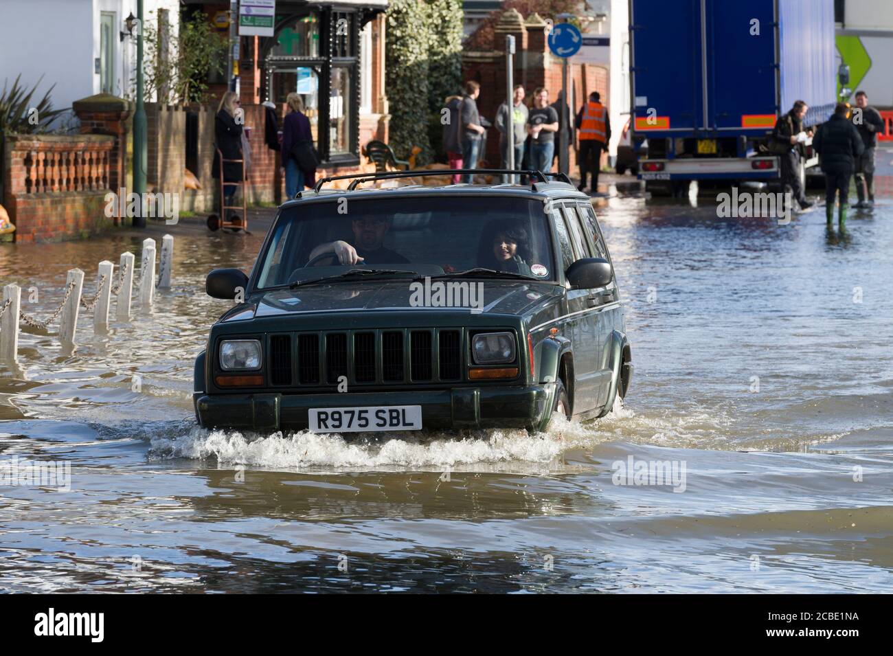 A car driving through flood waters on Slough road in the village of ...