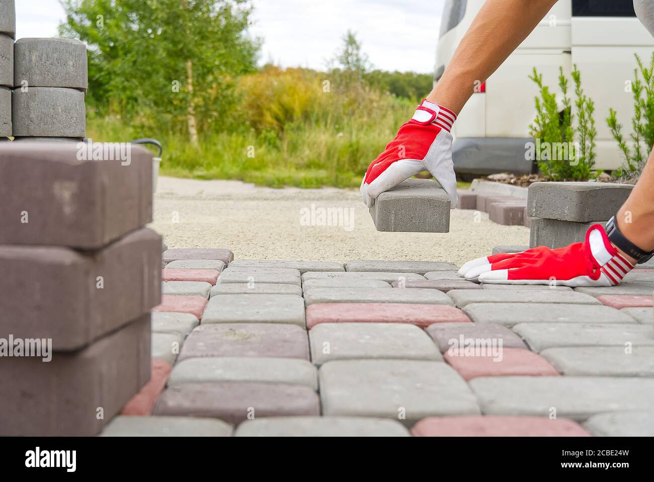 worker laying paving stones. stone pavement, construction worker laying ...