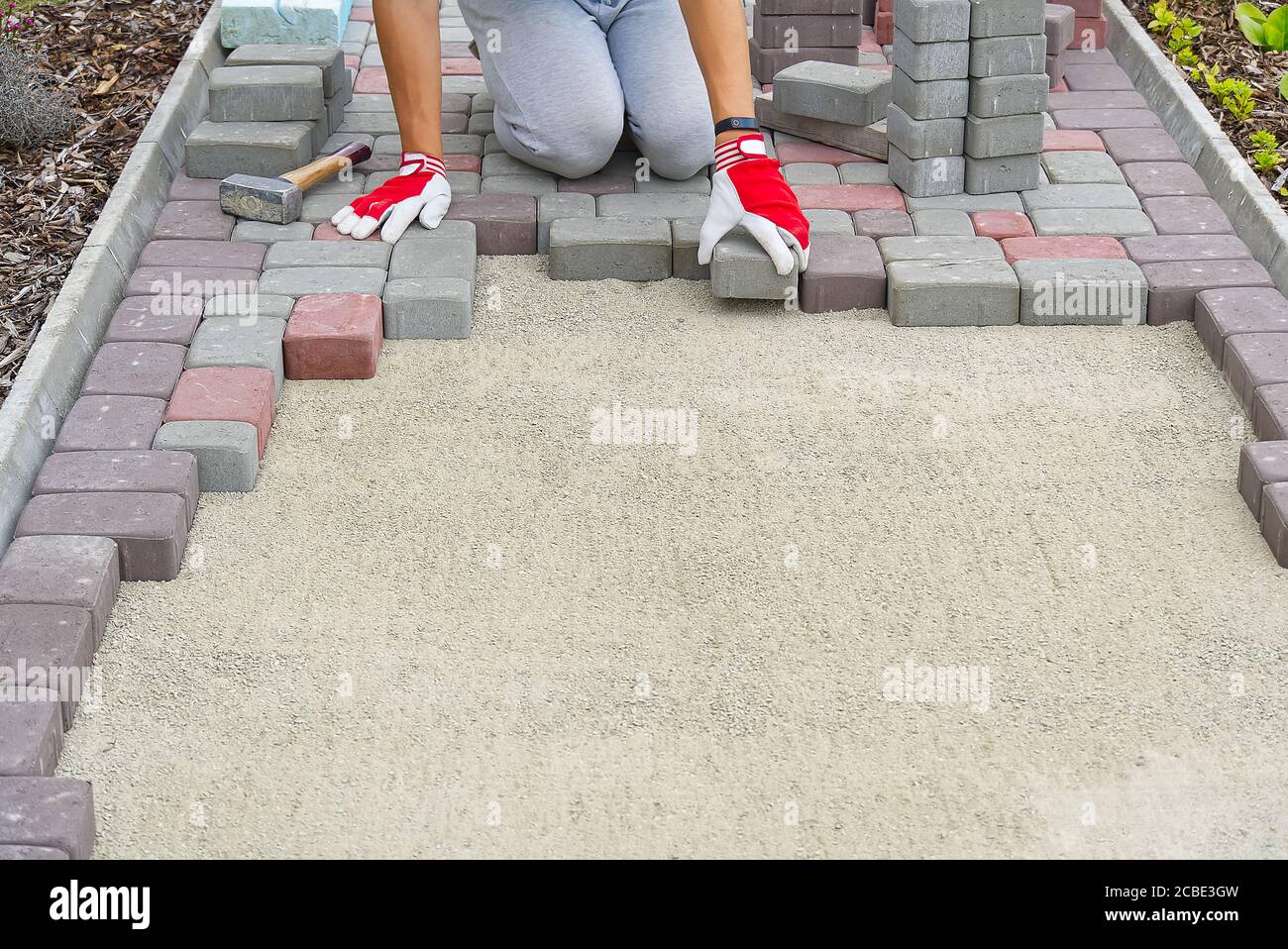 worker laying paving stones. stone pavement, construction worker laying ...