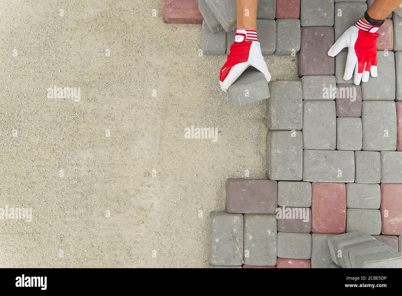 worker laying paving stones. stone pavement, construction worker laying ...