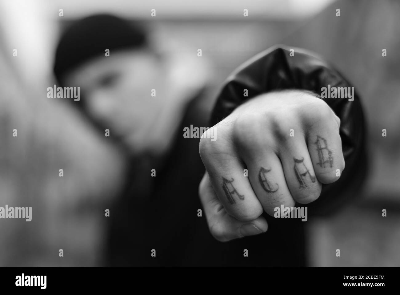 ACAB tattoo on the arm of a bully man. Black and white photo Stock ...
