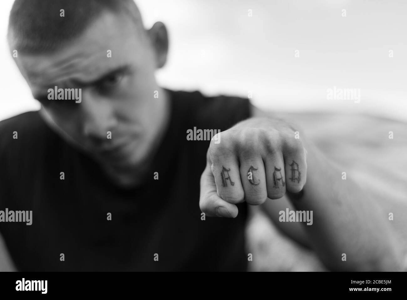 ACAB tattoo on the arm of a bully man. Black and white photo Stock ...
