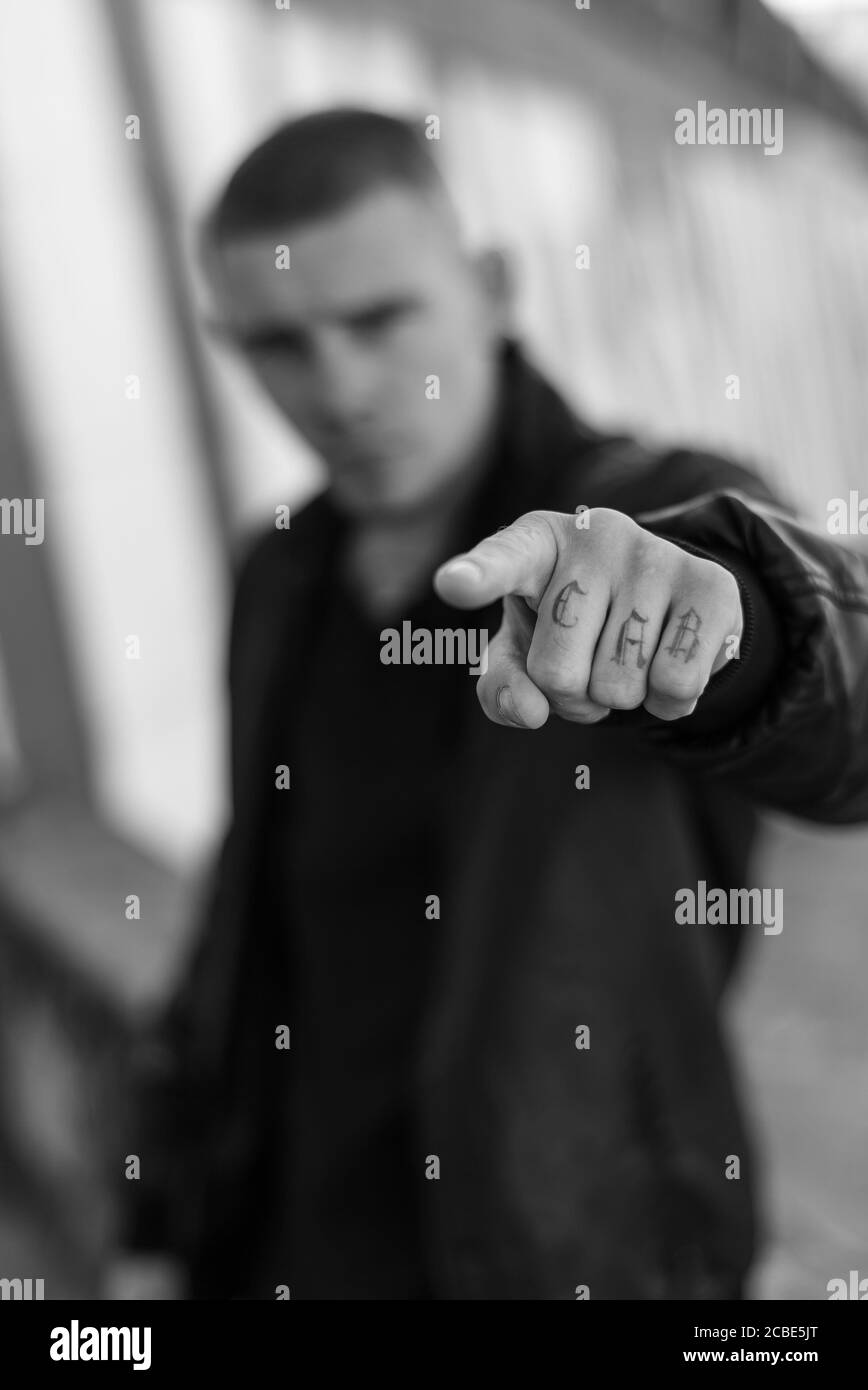 ACAB tattoo on the arm of a bully man. Black and white photo Stock ...