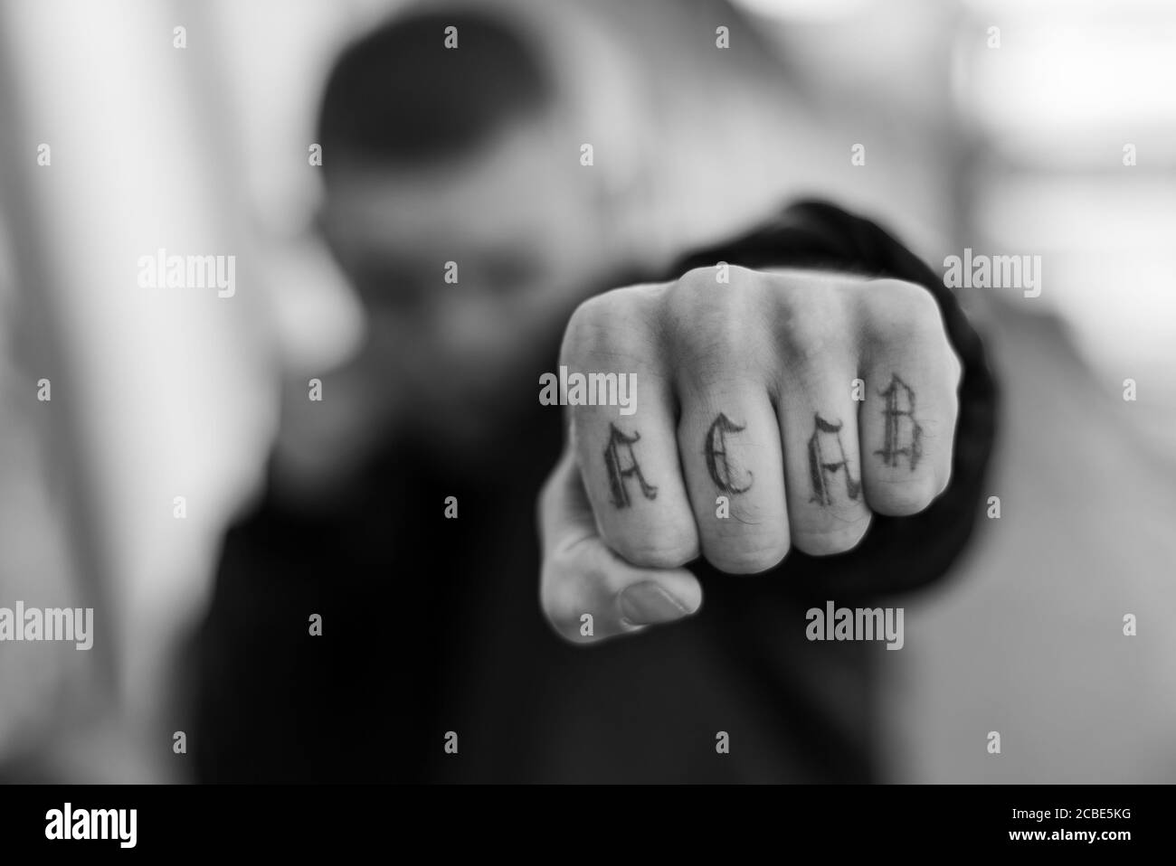 ACAB tattoo on the arm of a bully man. Black and white photo Stock ...
